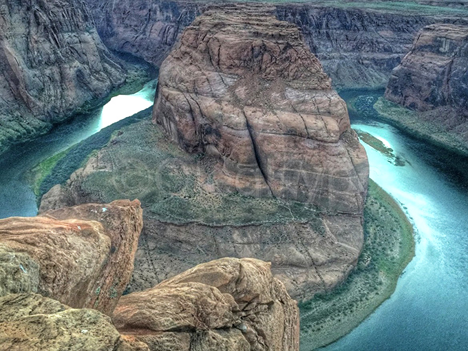 Standing at the precipice of wonder, where vertigo meets awe. The Colorado River's perfect horseshoe curve unfolds beneath curious onlookers.
