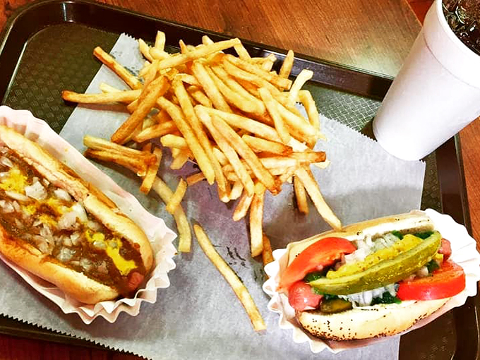 The holy trinity of comfort food: hot dog, fries, and a cold drink. It's like a hug for your taste buds.