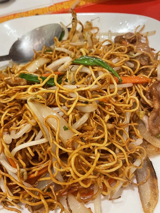 Cantonese chow mein delivers perfectly charred noodles tangled with vegetables, proving that simple dishes can be absolutely spectacular when done well.