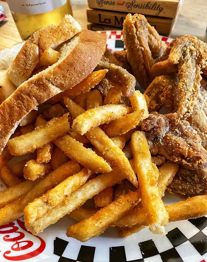 Wings and fries achieving that perfect golden ratio of crispy coating to tender meat that makes grown adults genuinely happy.