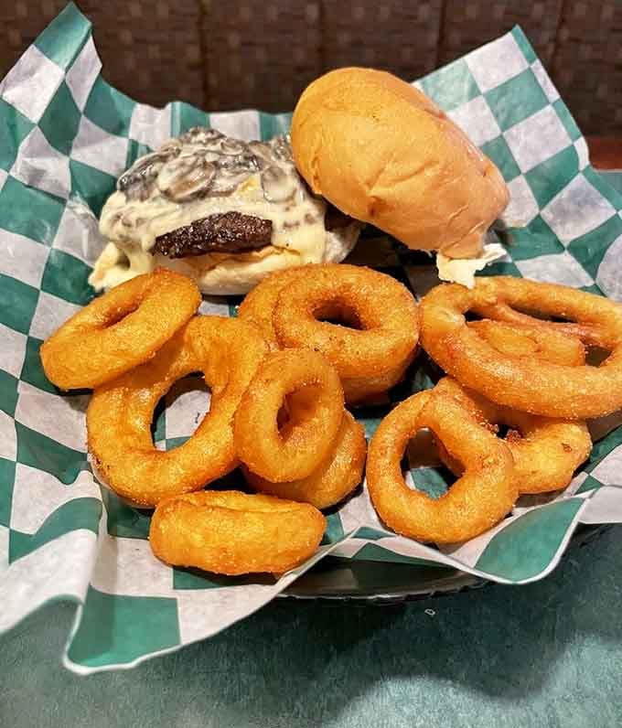 Golden onion rings arrive hot and crispy, the kind of appetizer that disappears faster than you can say "maybe we should have ordered two."