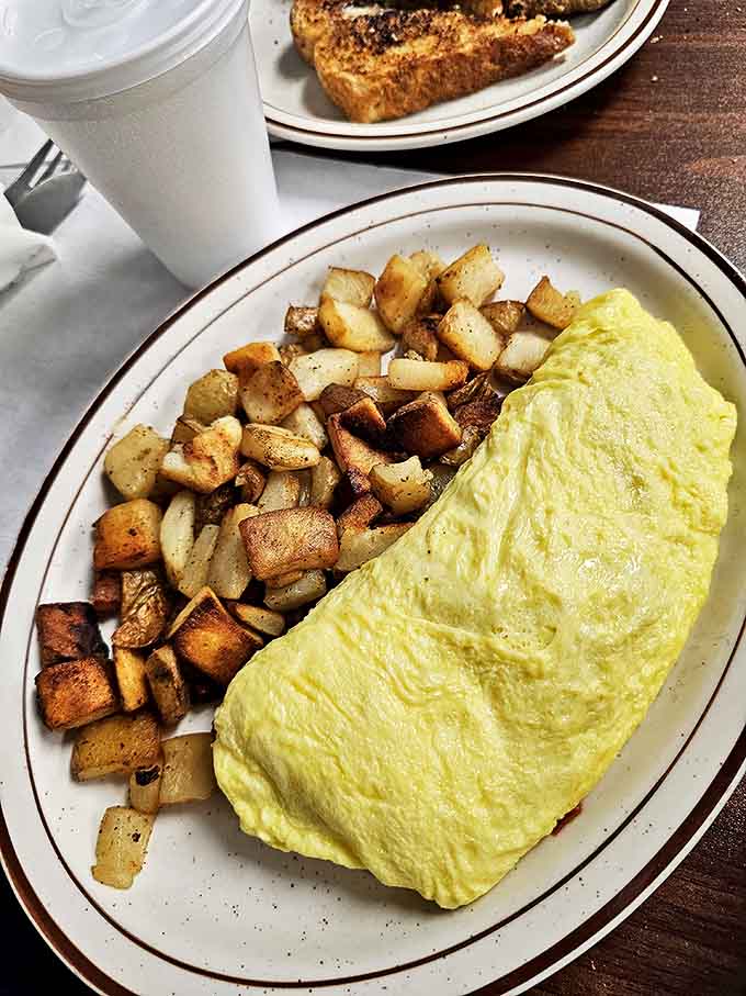 That omelet looks like a fluffy yellow cloud landed on your plate, stuffed with delicious fillings throughout.