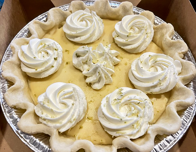 Key lime perfection with artfully piped whipped cream rosettes. The zesty filling and graham cracker crust create that perfect sweet-tart balance that makes you close your eyes involuntarily.