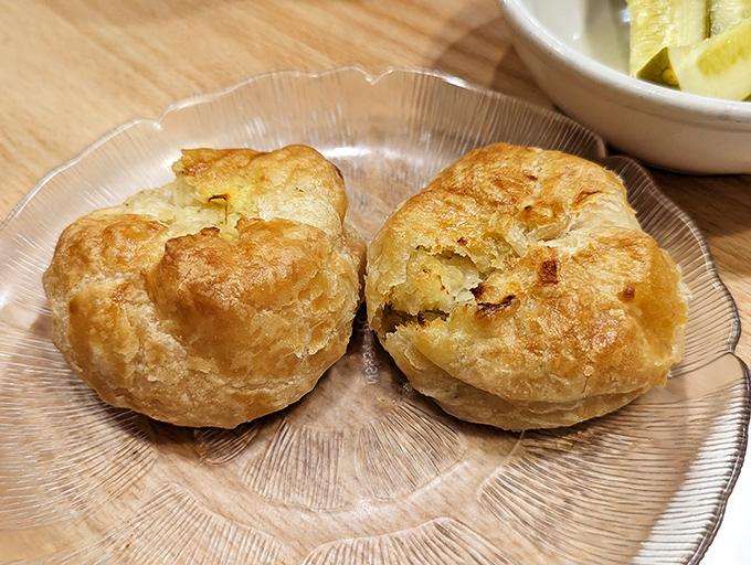 Freshly baked knishes &ndash; crispy on the outside, fluffy potato heaven within &ndash; carb perfection that your diet plan never saw coming.