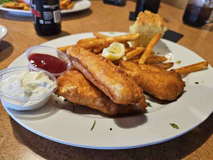 Golden-brown perfection on a plate, where each piece of fish promises that satisfying crackle when you cut into the crispy exterior.