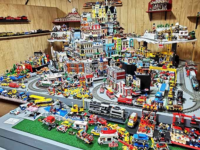 The Lego city display buzzes with miniature life – a colorful metropolis where tiny trains and vehicles move through a world built brick by meticulous brick.