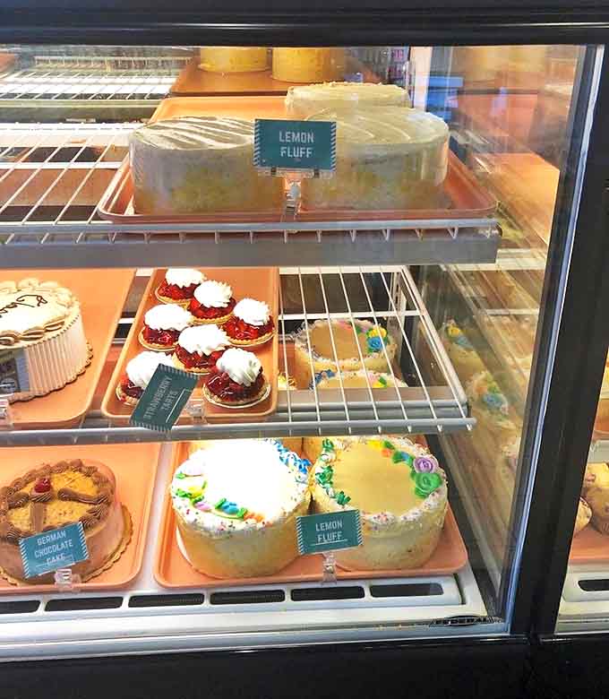 The display case showcases Wolf's greatest hits, but the Lemon Fluff Cakes command attention like celebrities at a hometown parade.