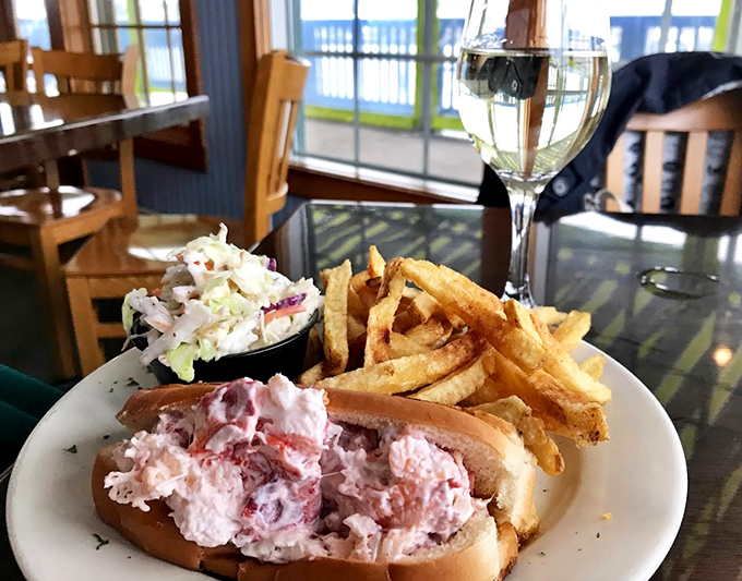 The classic coastal trifecta: a generous lobster roll, crispy fries, and coleslaw that actually deserves a place on your plate.