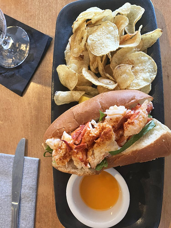 Surf meets turf... on a bun! This lobster roll's got more meat than a bodybuilder's Instagram, and those chips? Crispy perfection!