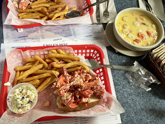 Maine's dynamic duo: a hearty lobster stew alongside the restaurant's famous lobster roll, both bursting with fresh catch.