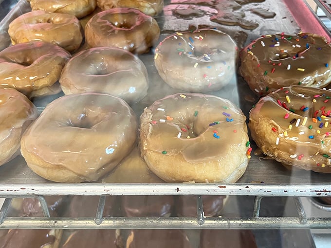 Glazed donuts glistening like morning dew &ndash; simple, classic, and utterly irresistible in their sweet, shiny glory.