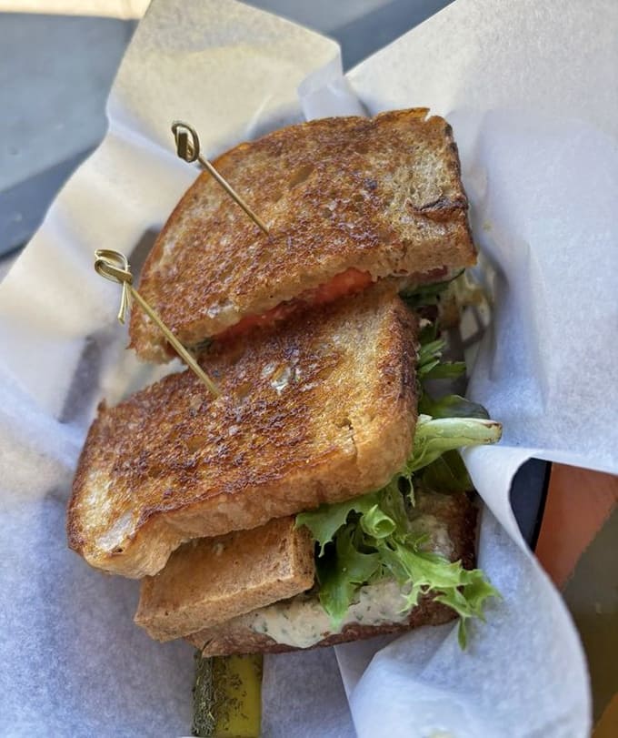 This breakfast sandwich is an engineering marvel, stacked with precision and grilled to golden perfection that would make any architect jealous.