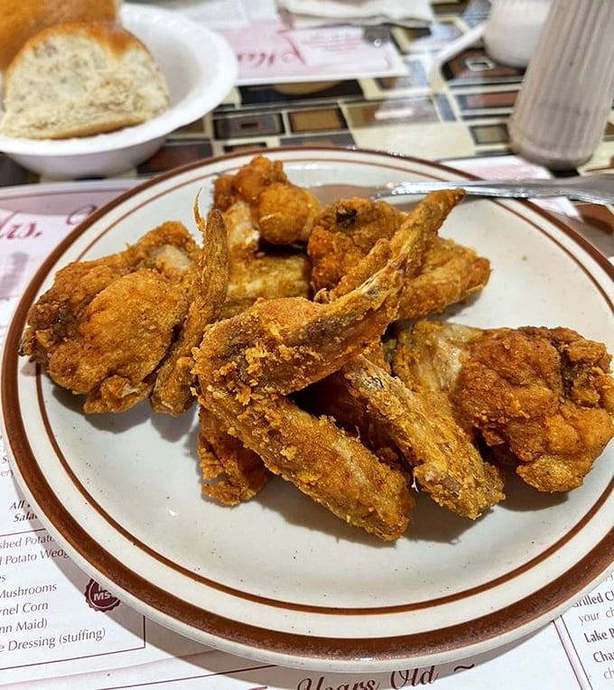 Golden fried chicken that's crispier than a autumn leaf and juicier than the latest gossip at the church social.