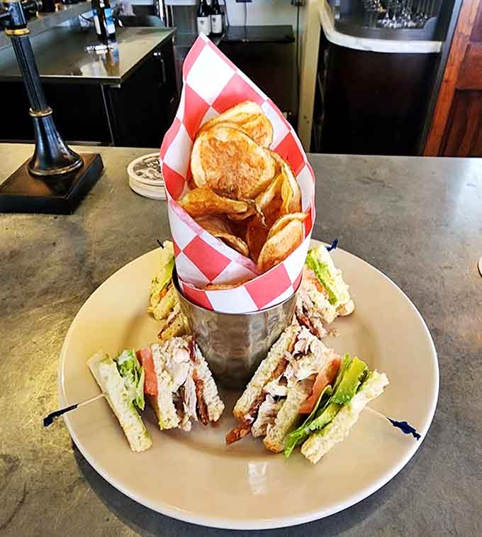 This club sandwich comes with chips standing at attention, ready to accompany layers of perfectly stacked deliciousness.