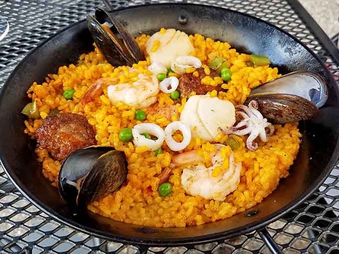 When your paella arrives looking like a Spanish vacation on a plate, complete with seafood treasures throughout.