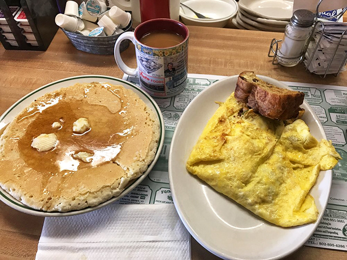 Pancakes so fluffy they practically float, served alongside a hearty omelet and steaming coffee.