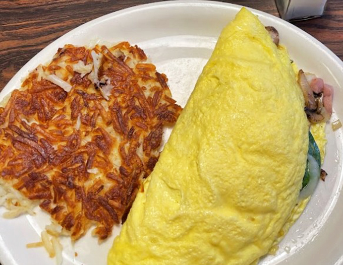 This isn't just any omelet &ndash; it's a fluffy envelope of morning joy, accompanied by the hash browns that put Parker on the culinary map.
