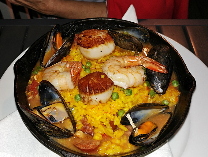 A saffron-hued canvas showcasing the ocean's finest &ndash; where plump mussels, tender shrimp, and scallops create a symphony of flavors.