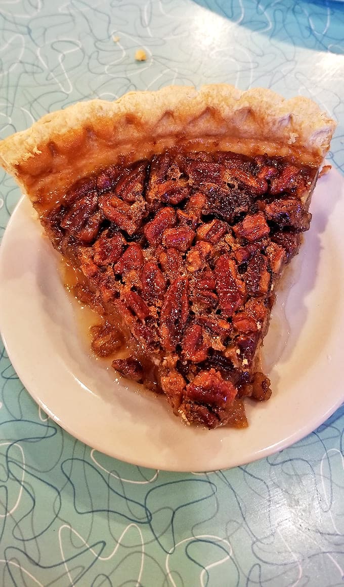 A perfect symphony of gooey filling and crunchy pecans in a flaky crust. This isn't just pie – it's an edible work of art.