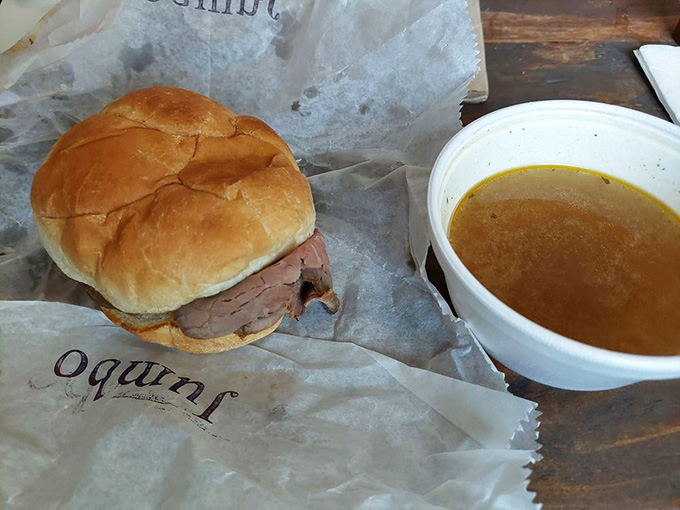 Tender roast beef nestled in a soft bun with a side of rich au jus, perfect for dunking.