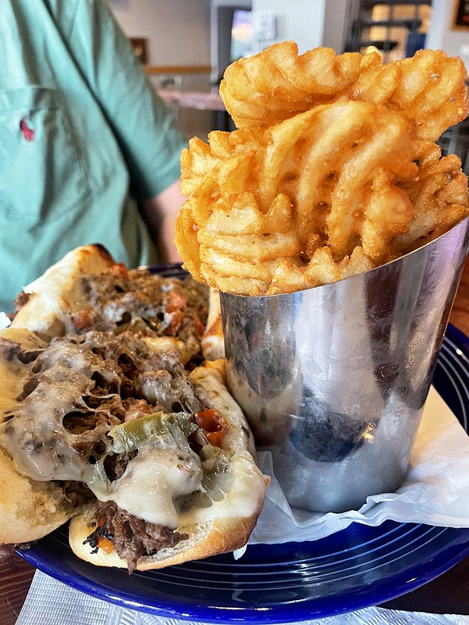 The holy grail of comfort food: A perfectly melted cheesesteak alongside golden waffle fries that could make a potato proud.