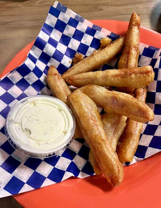 Golden, crispy fries that could make a French chef weep with envy, served with creamy dipping sauce for maximum indulgence.