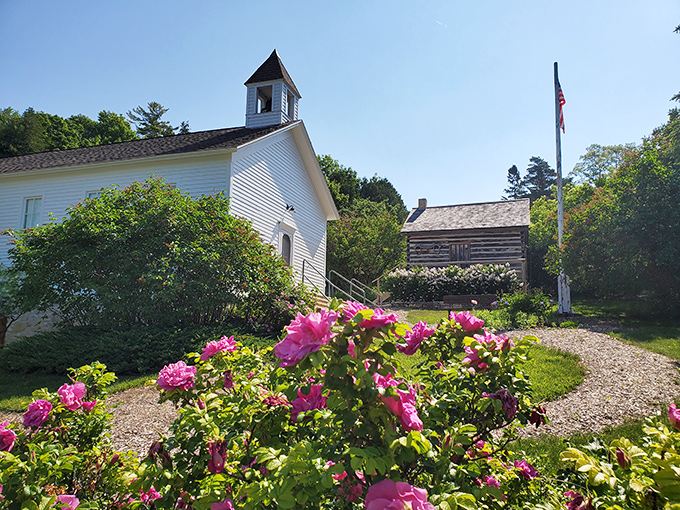 History blooms alongside vibrant flowers at this pristine white chapel, where Door County's past is lovingly preserved.