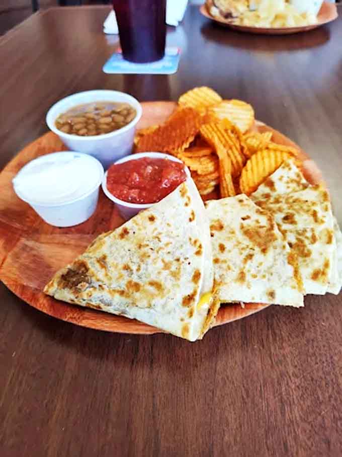 Melted cheese hugs savory fillings between griddled tortillas, creating a quesadilla that's both simple and sublime &ndash; comfort food with a southwestern twist.