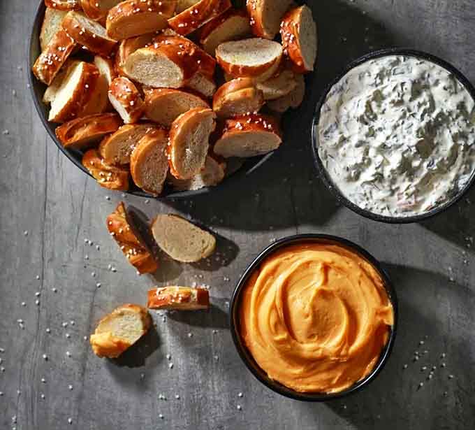 A tray of pretzel bites with dipping options &ndash; proof that sometimes the best things come in small, salty packages.
