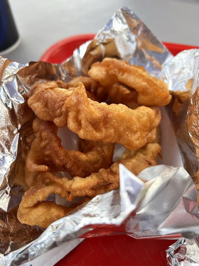 Golden onion rings that achieve crispy perfection are the supporting actors that deserve their own standing ovation at Red's Eats.