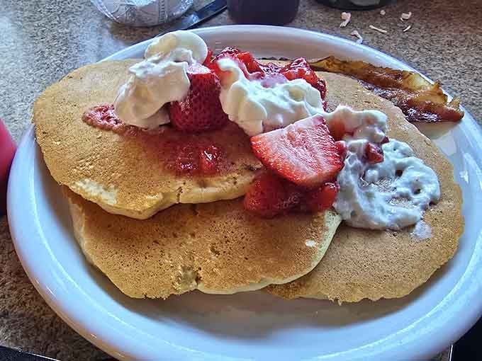Fluffy pancakes topped with strawberries and whipped cream prove that some classics never need improving, just proper execution.