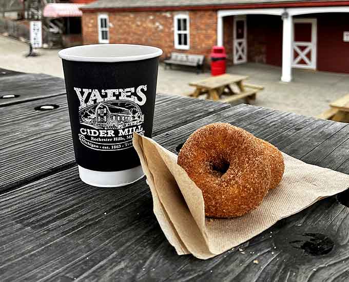 Cider Donut: The hero of our story &ndash; a perfectly golden donut alongside steaming cider, creating a moment of pure Michigan magic.