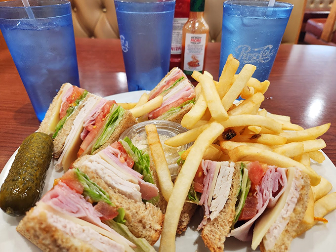 A classic club sandwich that towers like Chicago's skyline, accompanied by perfectly golden fries.