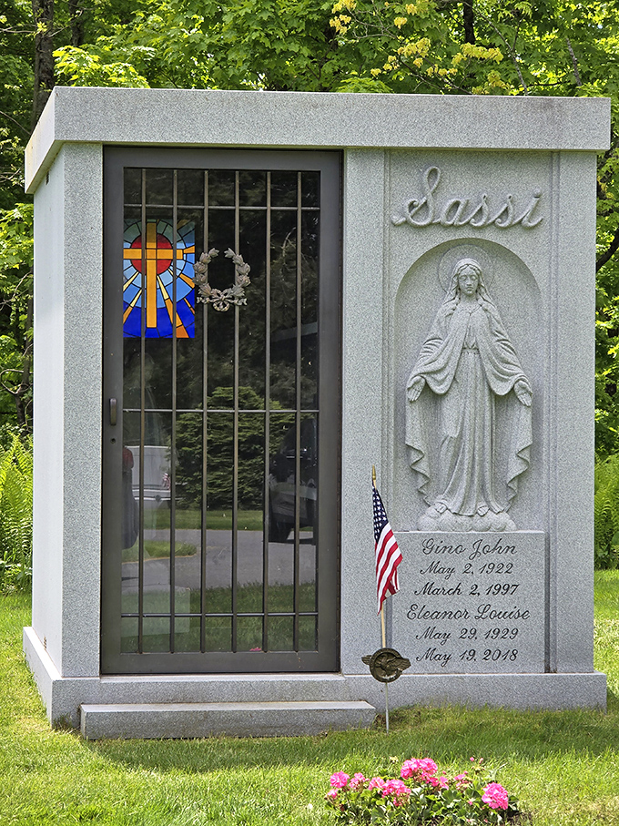 The Sassi family mausoleum combines religious imagery with architectural elegance, its stained glass window casting colorful light on the interior sanctuary.