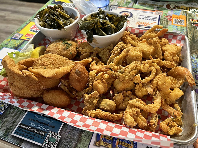 The motherload of fried goodness &ndash; a golden-brown archipelago of seafood treasures surrounded by collard green islands.