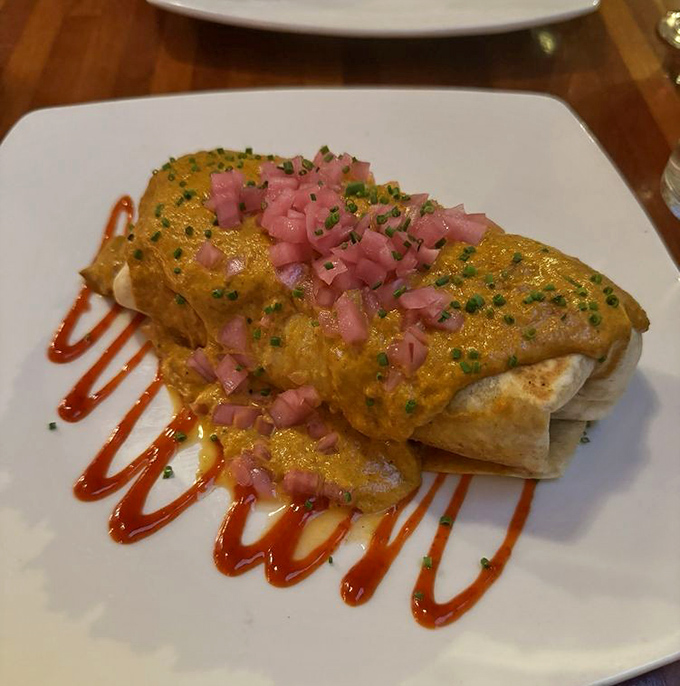 A culinary passport stamped with flavor &ndash; tender chicken wrapped in a warm tortilla, smothered in aromatic butter sauce and topped with diced ham for a salty counterpoint.