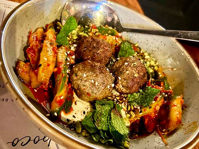 Spiced meatballs nestled among vibrant vegetables &ndash; each bite delivers a perfect balance of tender meat and exotic spices that dance across your palate.