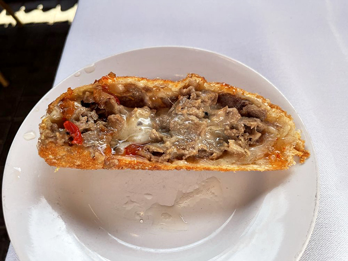 Crispy exterior gives way to savory filling &ndash; a perfect harmony of textures that makes you reach for another before finishing the first.