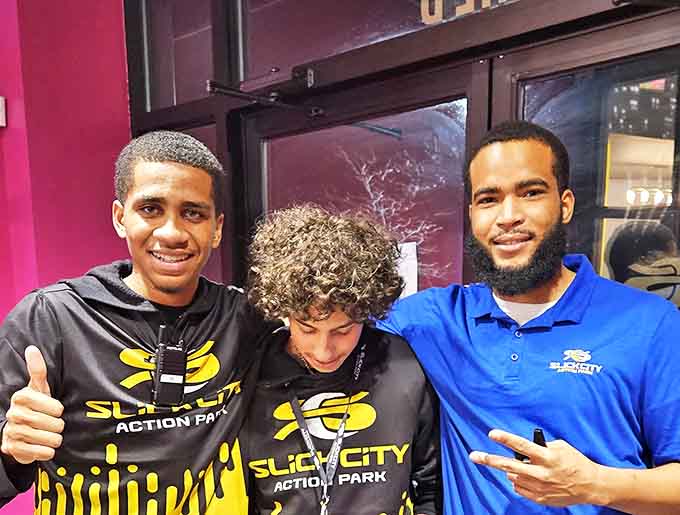 The enthusiastic staff members showcase their passion for fun, ready to guide visitors through adventures in sliding, jumping, and dignity-testing.