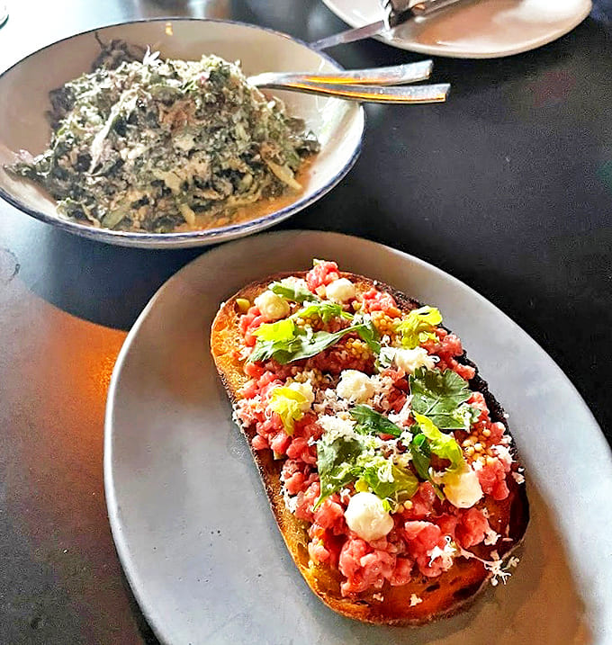 Steak Tartare Toast: Rustic bread provides the perfect stage for this beef performance. Fresh herbs add bright notes to the meaty melody.