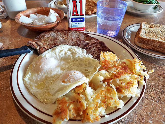The classic steak and eggs – where a perfectly seared cut meets sunny-side up companions and golden hash browns.