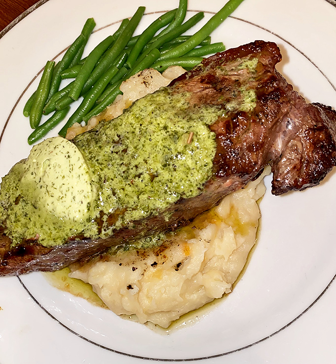 The filet mignon arrives perfectly charred outside, tender within, crowned with b&eacute;arnaise sauce that adds buttery brightness to each savory bite.