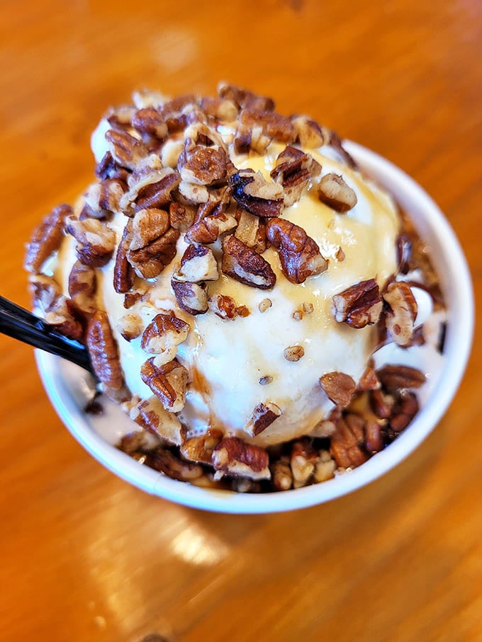 Sundae with Toppings: Pecans cascade over vanilla ice cream like tiny flavor grenades, proving that sometimes the best accessories are the ones you can eat.