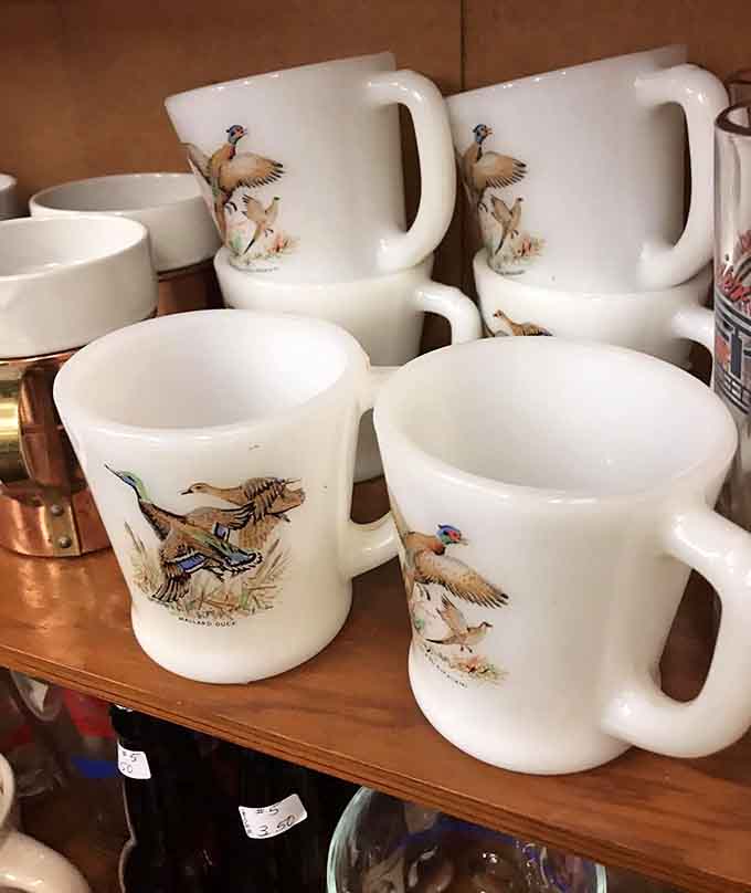 Pheasant-adorned mugs line up like they're ready for the world's fanciest hunting lodge coffee break, minus the actual hunting.