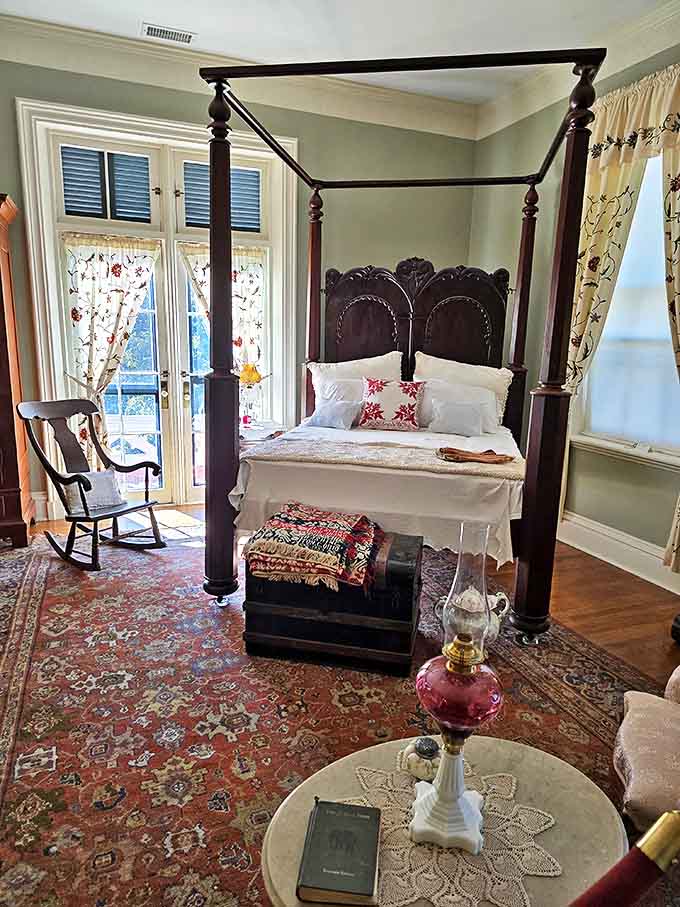 This four-poster bed has cradled dreams for over a century, in a room where morning light filters through vintage lace curtains.