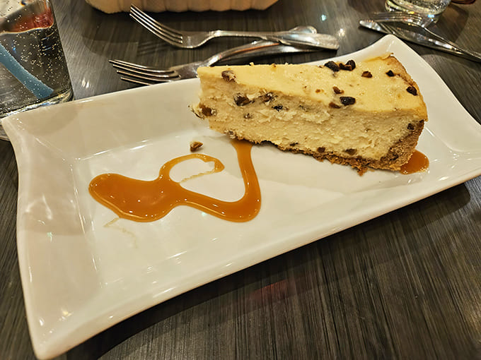 A slice of heaven on a plate &ndash; the cheesecake with caramel drizzle demonstrates why dessert stomachs are scientifically proven to exist.