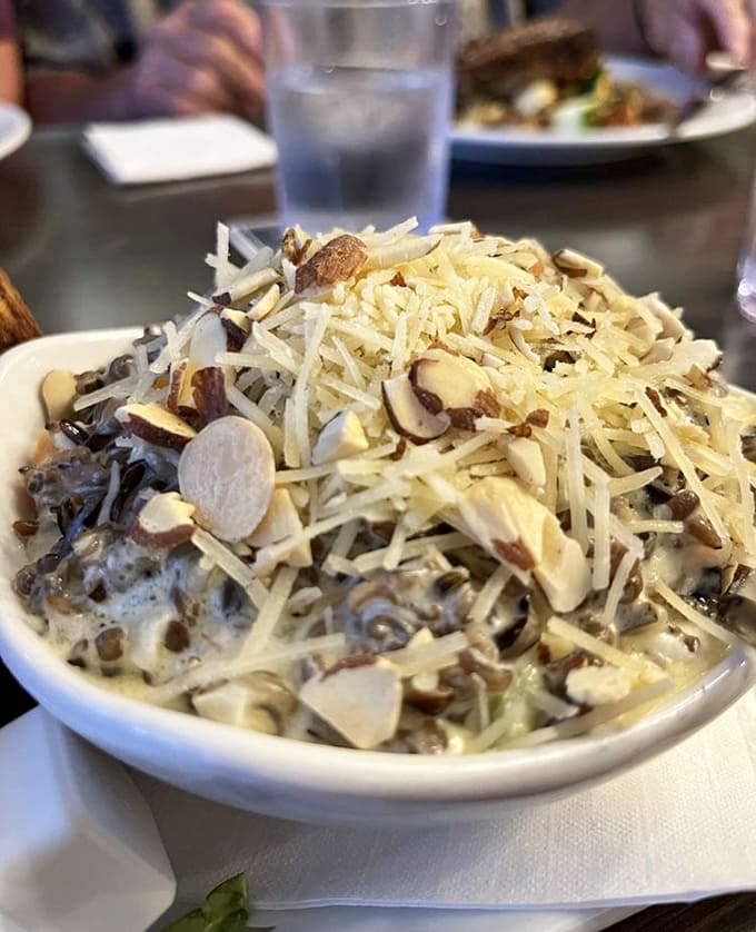 Wild rice hotdish gets a gourmet makeover, blanketed in cheese and toasted almonds that add sophisticated crunch to comfort food.