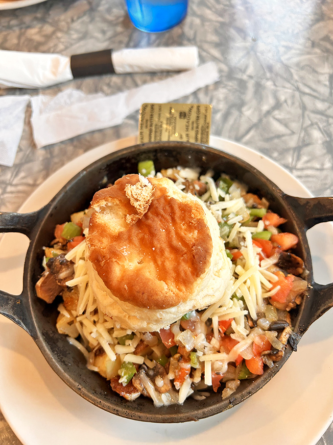 The Veggie Skillet proves meatless doesn't mean flavorless, with colorful vegetables dancing beneath eggs and cheese in a cast-iron masterpiece.