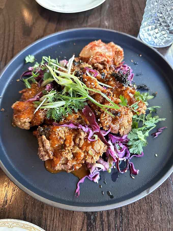 Crispy fried chicken meets tangy slaw in this dish that proves sometimes the best appetizers steal the show from the main event entirely.