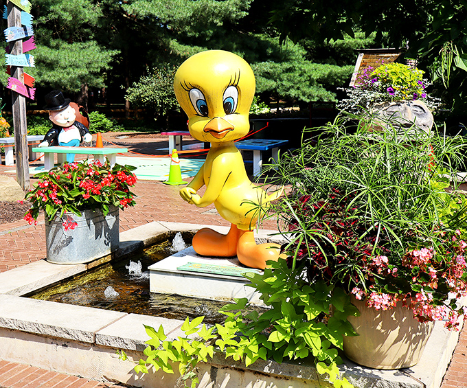 "I tawt I taw a magical garden!" Tweety Bird stands guard over this whimsical water feature with cartoon confidence.